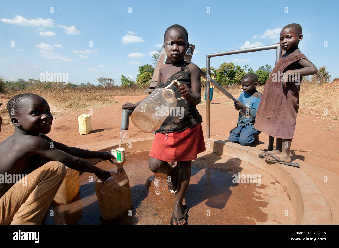 Uganda. Gulu. Children collect water at village borehole Stock Photo ...