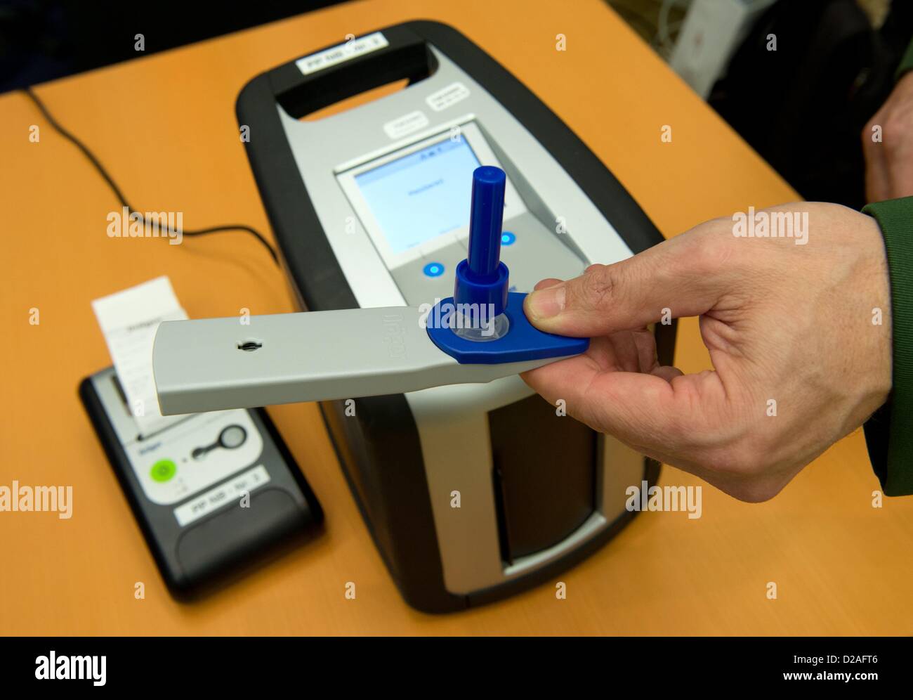 A police officer presents a new quick drug detection device in Munich ...