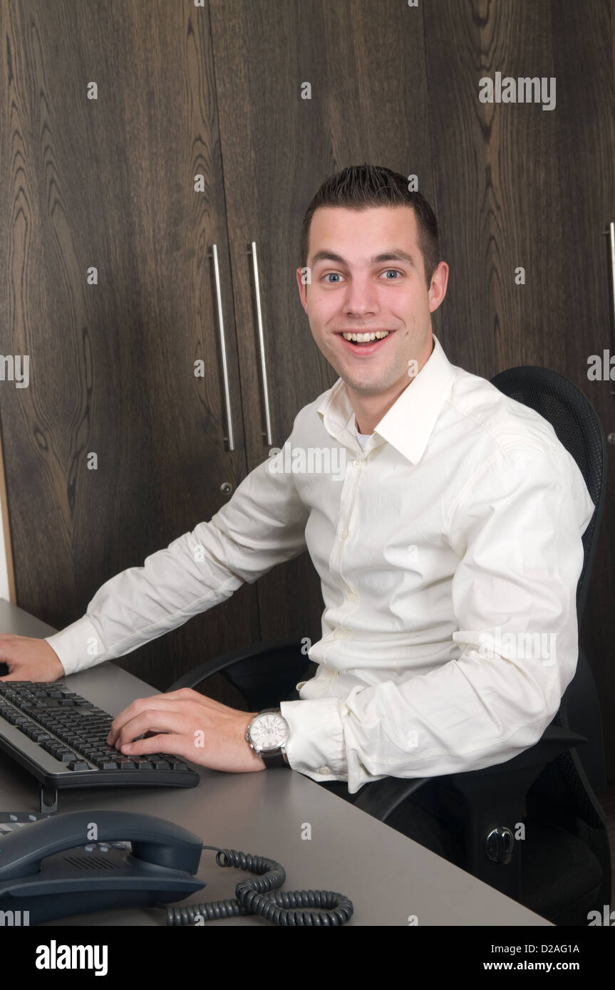Male working at a computer in an office Stock Photo - Alamy