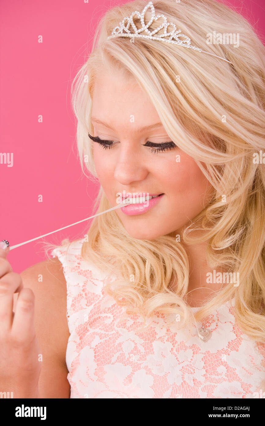 Pretty teenage girl playing with her chewing gum Stock Photo - Alamy
