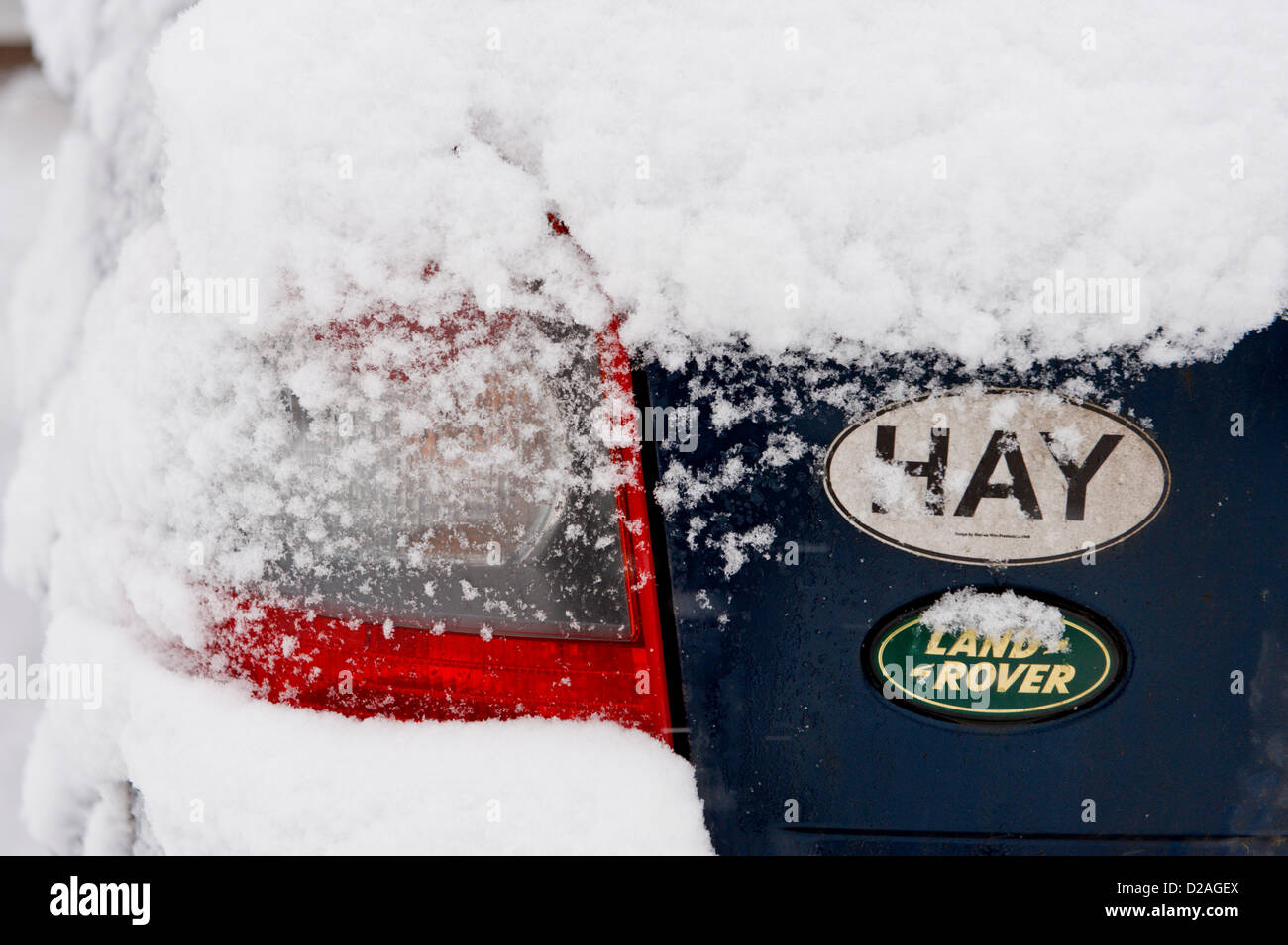 Land Rover 4x4 covered in snow with Hay sticker. Hay-on-Wye Powys Wales ...