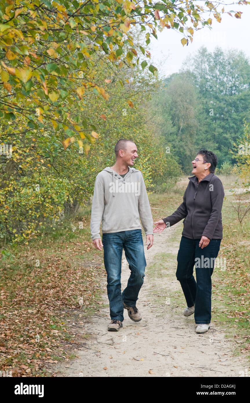 Man and a woman having a walk in the forest Stock Photo - Alamy