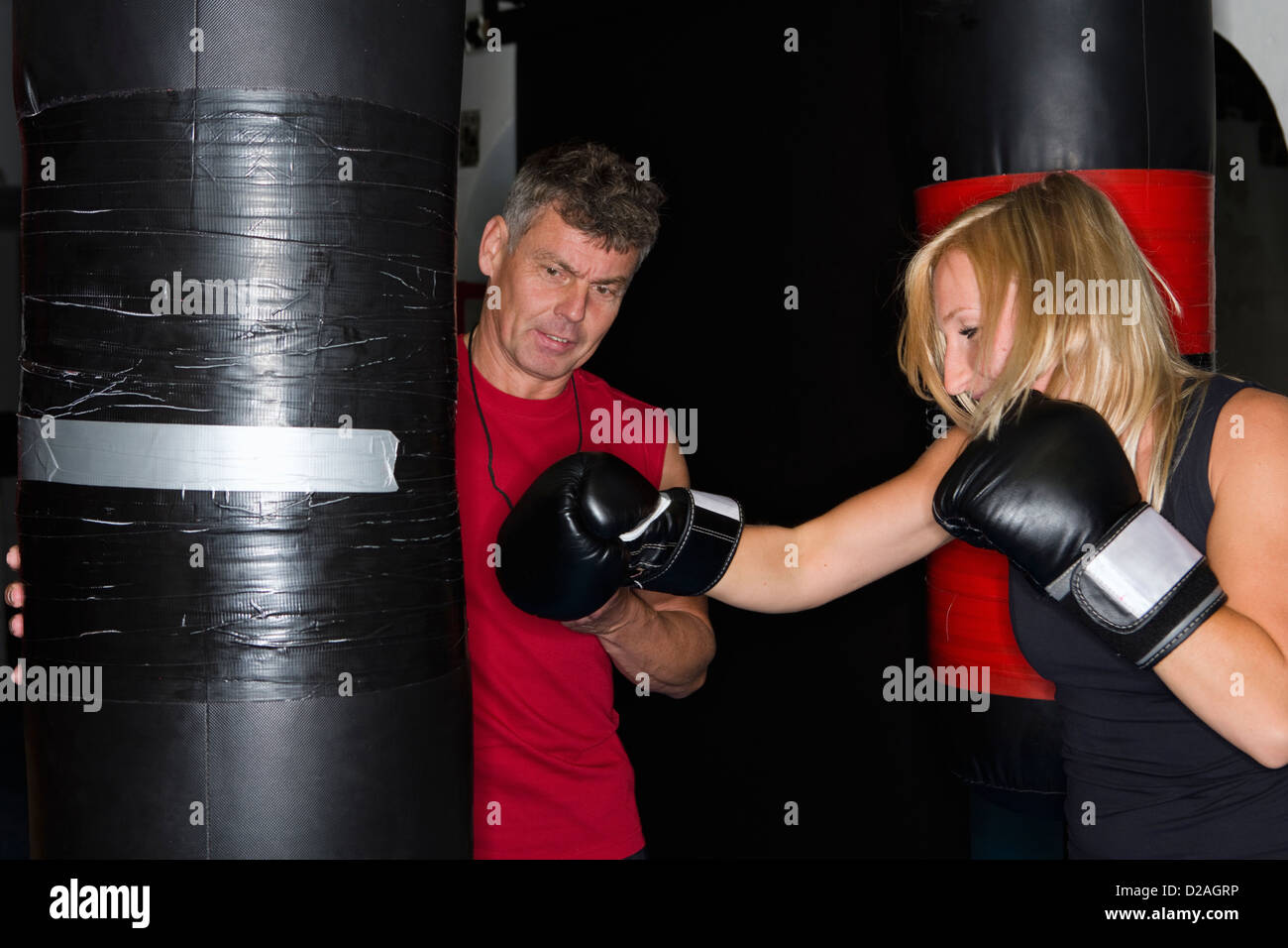 Boxer working with trainer in gym Stock Photo - Alamy
