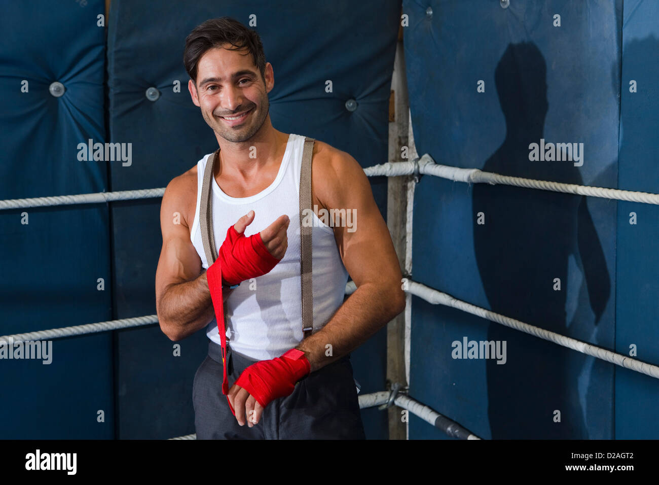 Boxer wrapping his wrists in ring Stock Photo - Alamy