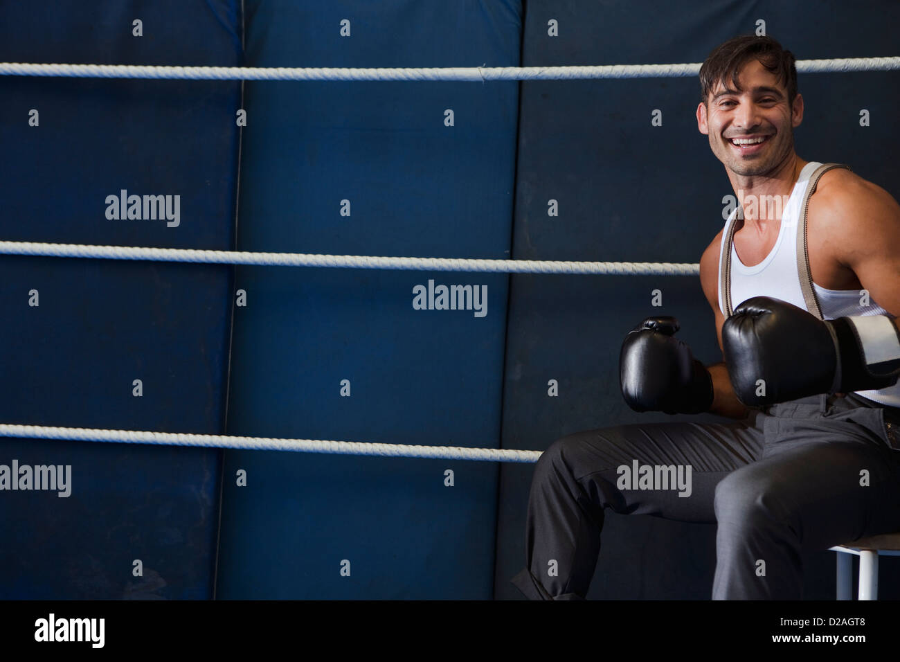 Smiling boxer sitting in ring Stock Photo - Alamy