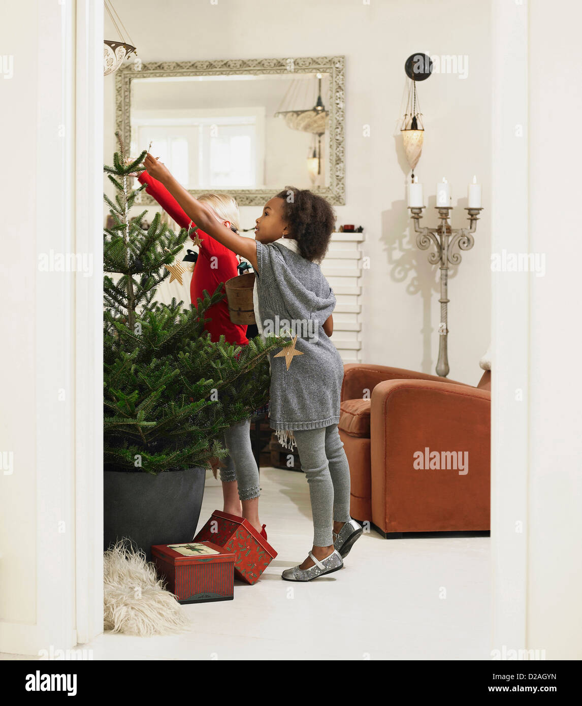 Girls decorating Christmas tree Stock Photo - Alamy