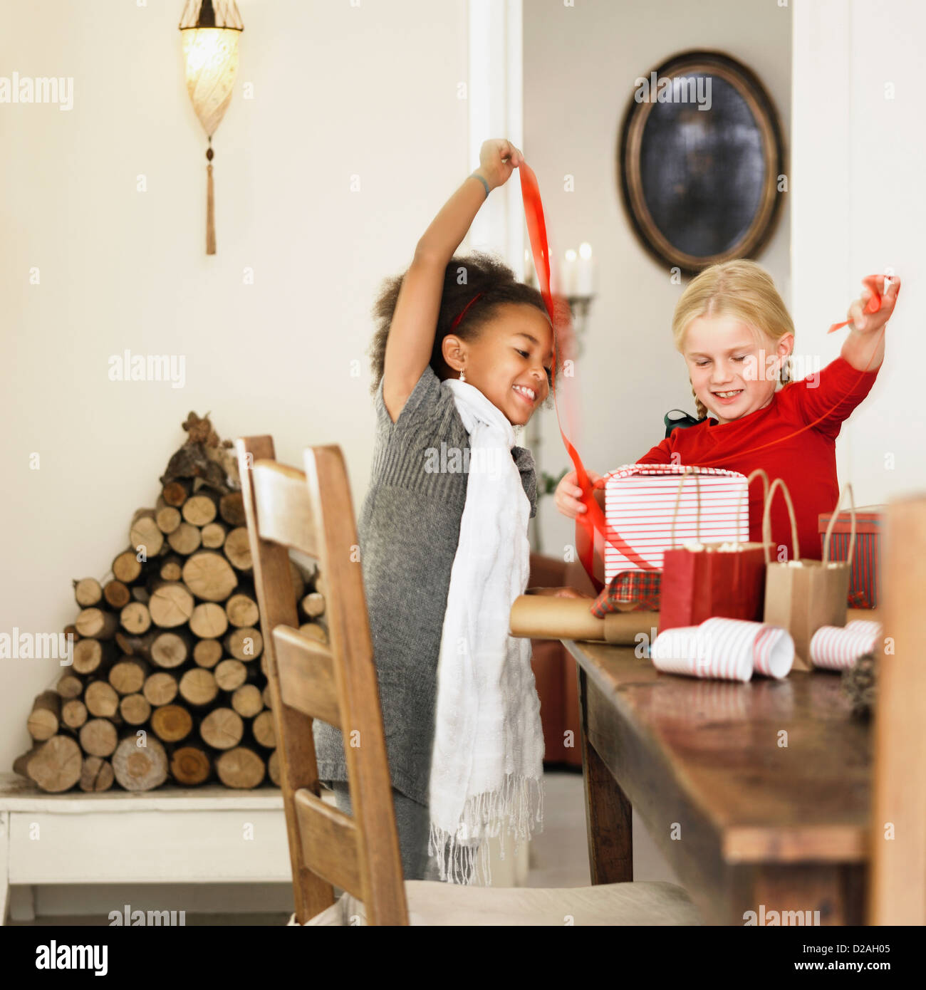 Girls wrapping Christmas presents Stock Photo - Alamy