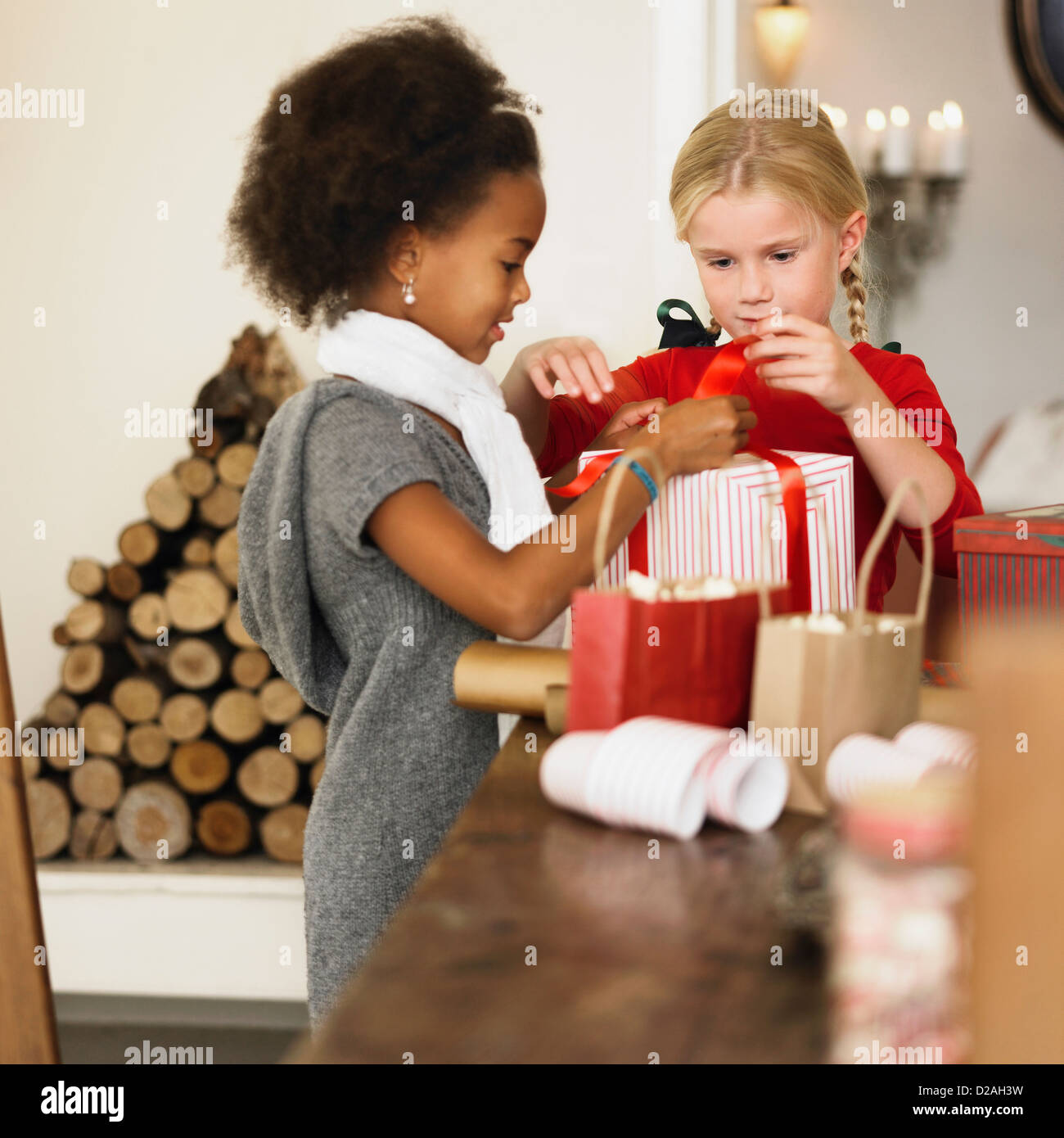 Girls wrapping Christmas presents Stock Photo - Alamy
