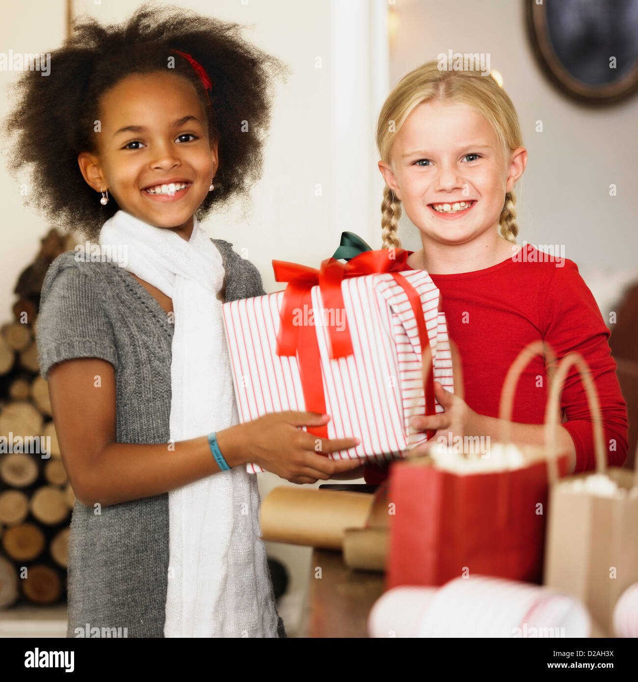 Girls wrapping Christmas presents Stock Photo - Alamy