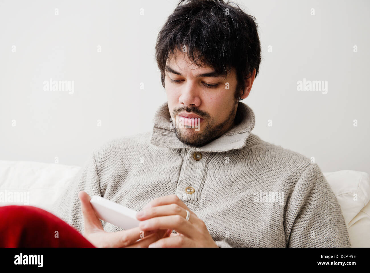 Mobile man seat on sofa hi-res stock photography and images - Alamy