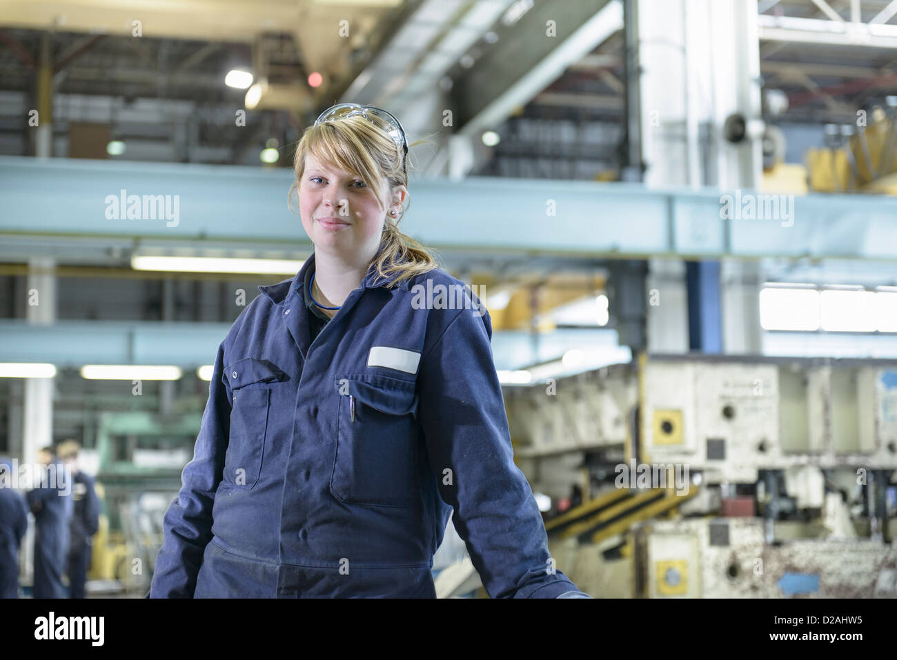 Apprentice standing in car factory Stock Photo - Alamy
