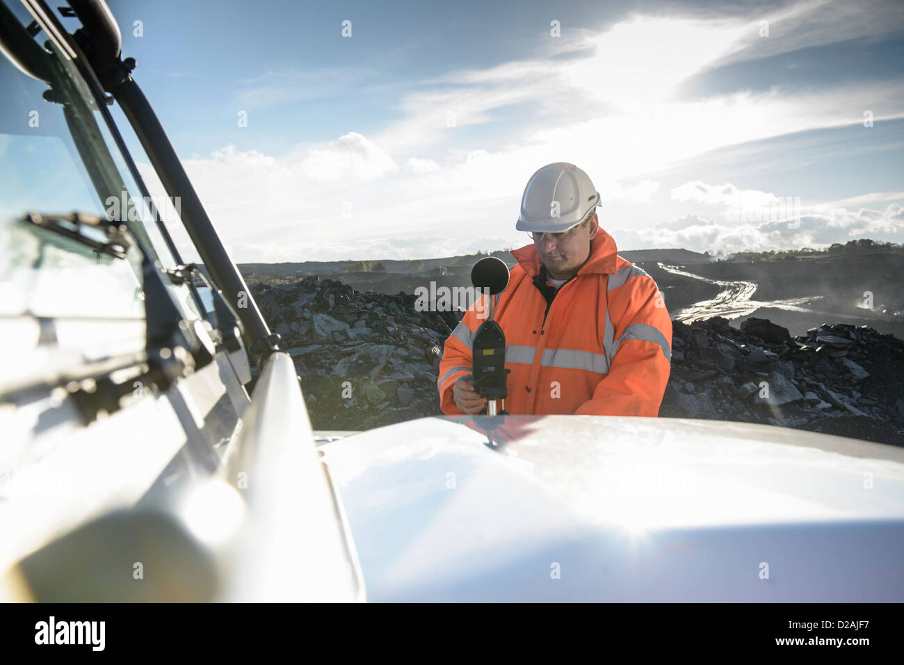 Worker using noise equipment on truck Stock Photo - Alamy