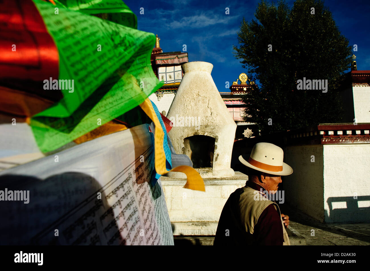 a pilgrim with white hat by prayer flags, lhasa, tibet, china Stock ...