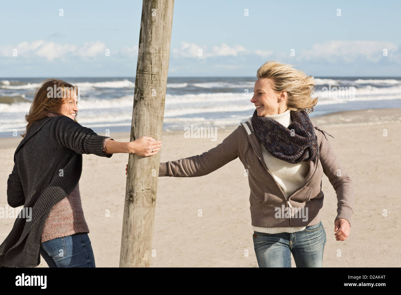 Woman holding pole on beach hi-res stock photography and images - Alamy