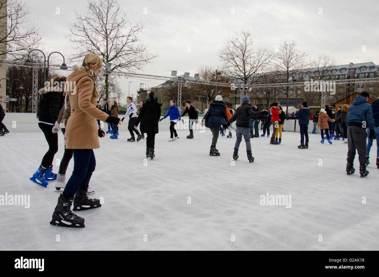 Germany, Cologne. Annual Christmas Market, children and teens skating ...