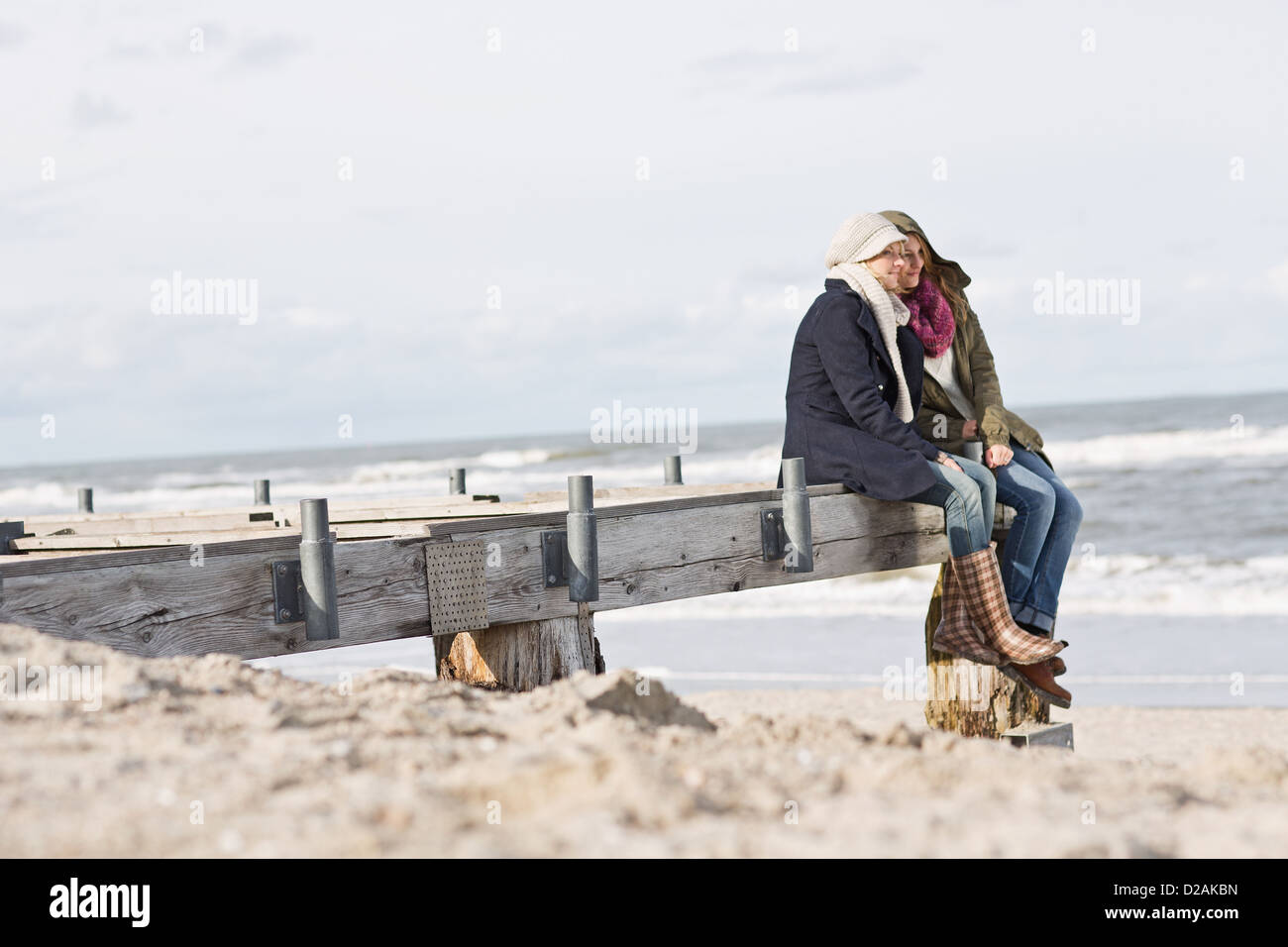 Women relaxing together on pier Stock Photo - Alamy