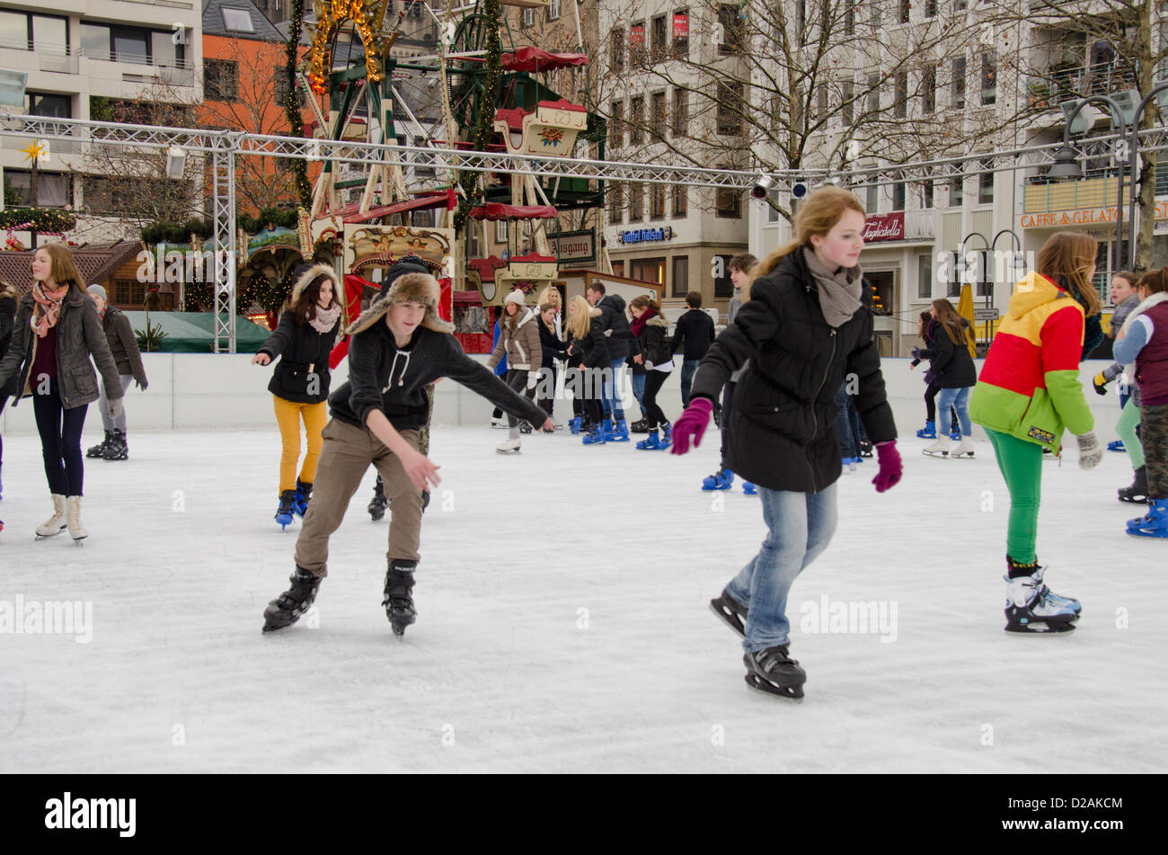 Germany, Cologne. Annual Christmas Market, children and teens skating ...