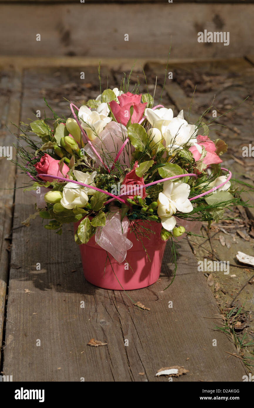 Beautiful flower display in pink bucket Stock Photo - Alamy