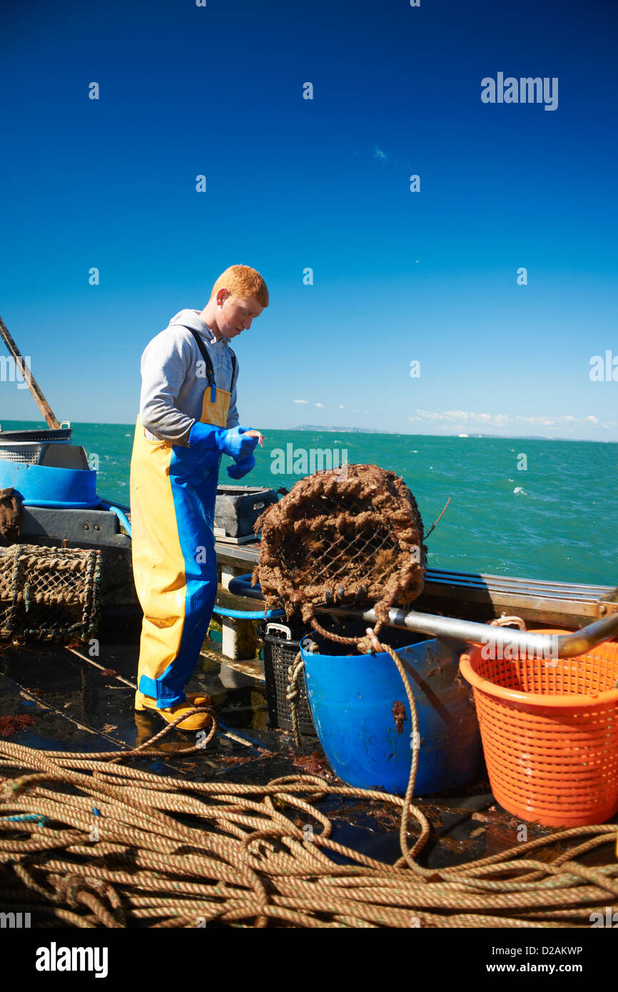 Fisherman at work on boat Stock Photo - Alamy