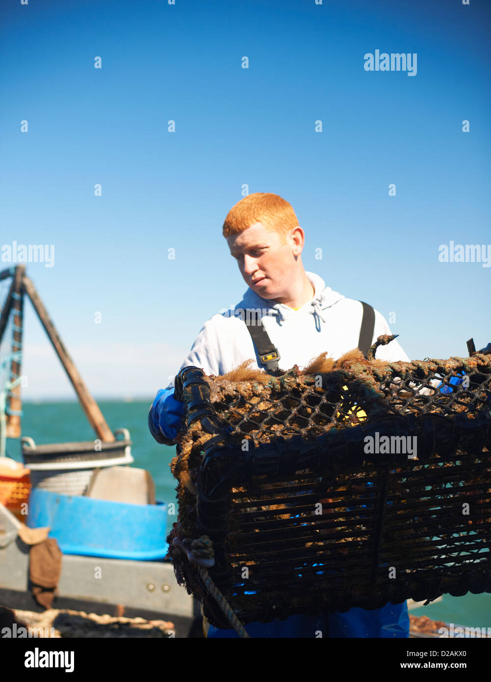 Fisherman at work on boat Stock Photo - Alamy