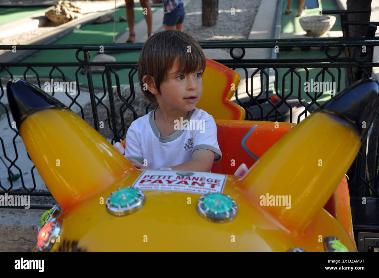 5-years old young boy in a Merry-go-round Car Stock Photo - Alamy