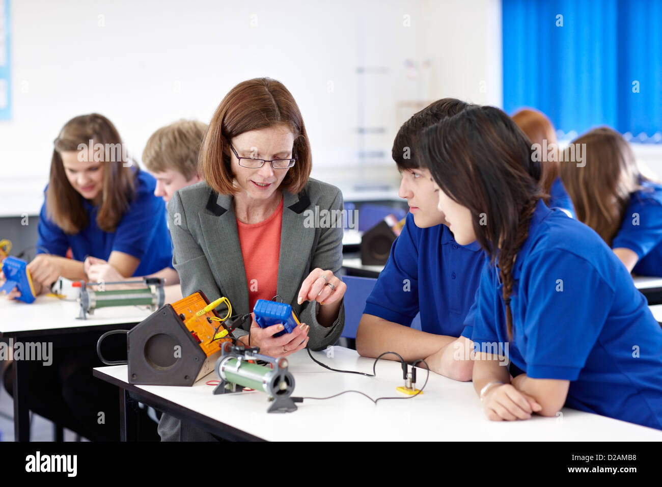 Teacher with students in science class Stock Photo - Alamy