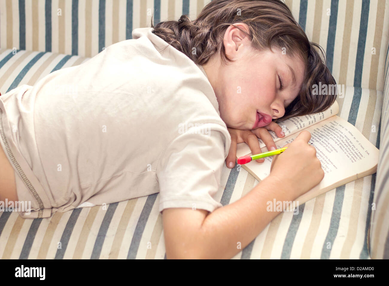 A young boy falls asleep while reading a book Stock Photo - Alamy