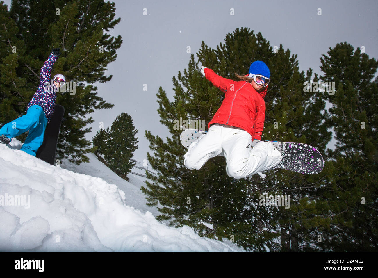 Snowboarder jumping on snowy slope Stock Photo - Alamy