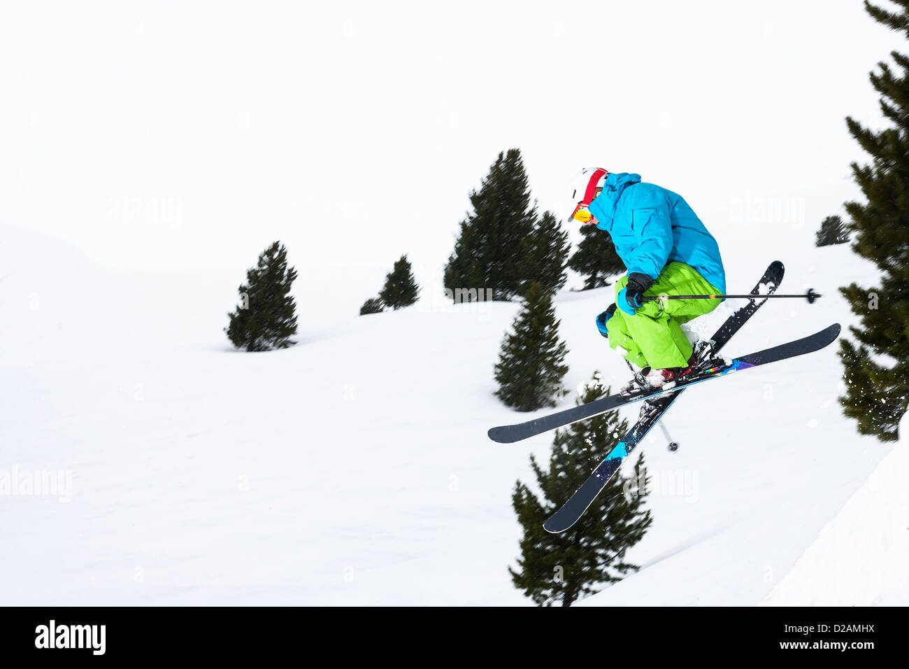 Skier jumping on snowy slope Stock Photo - Alamy