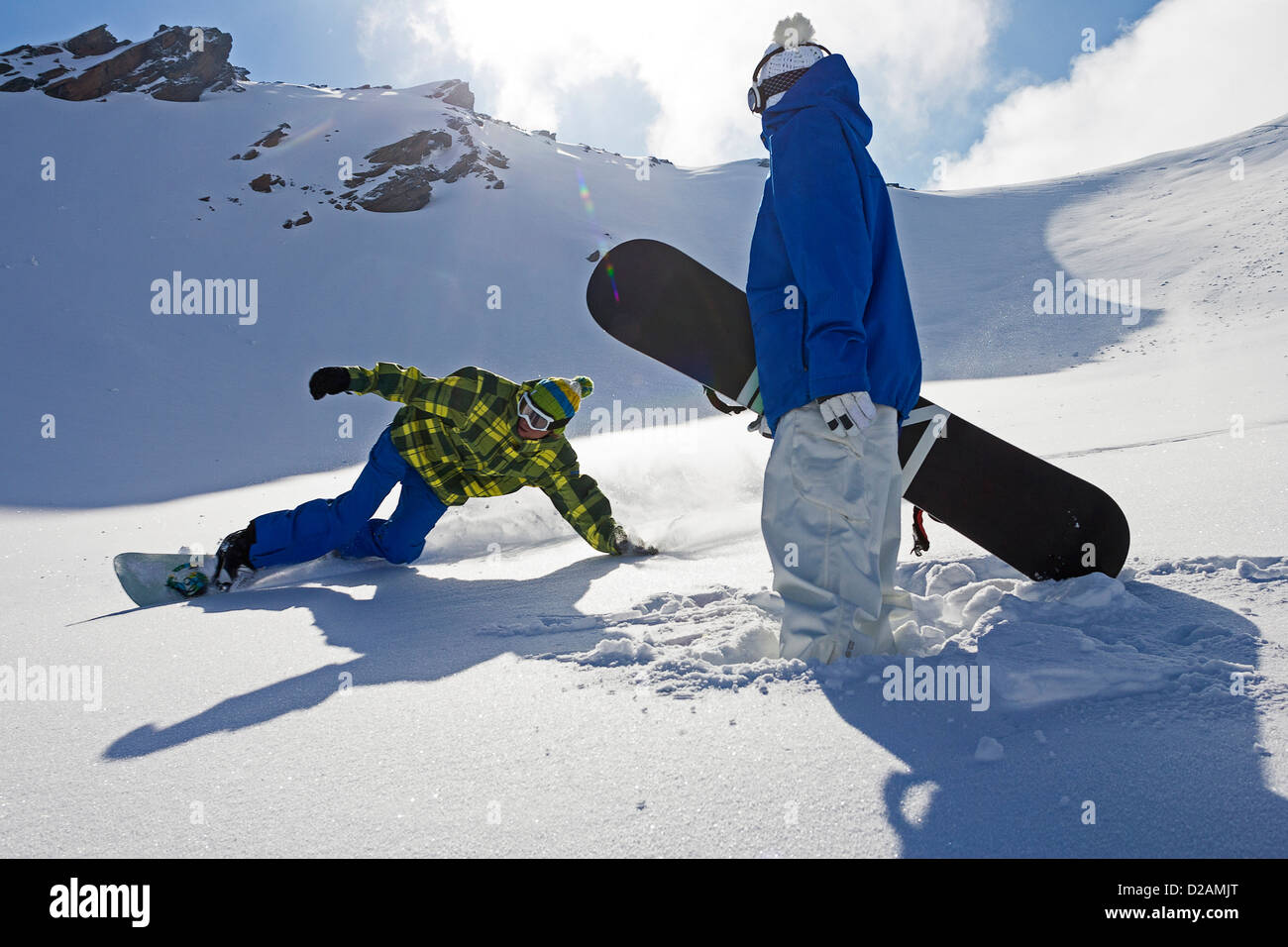 Snowboarders on snowy slope Stock Photo - Alamy