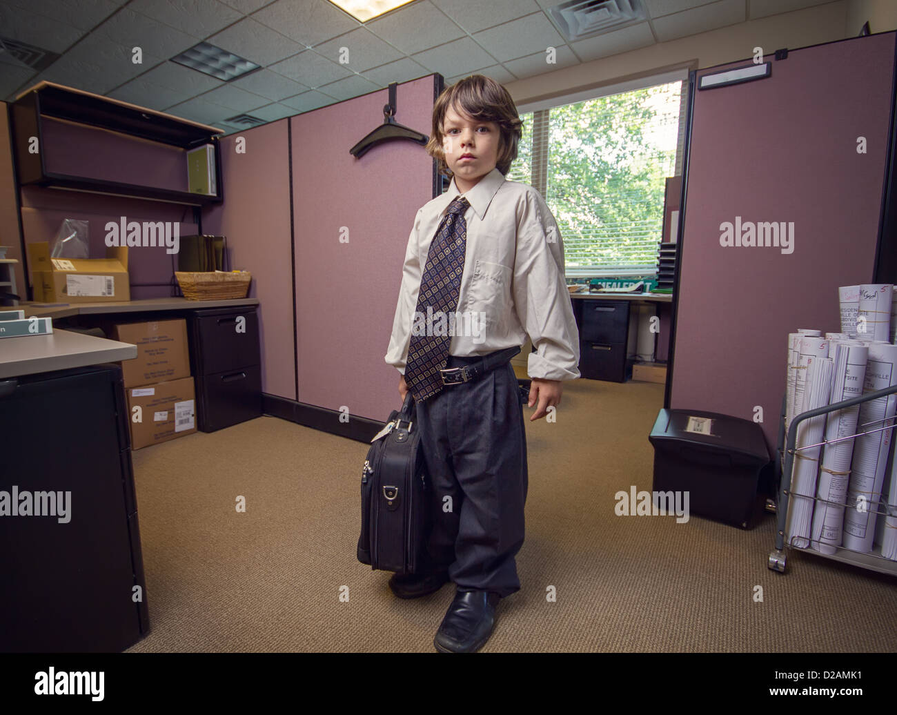 Young boy dresses in work clothes in an office setting Stock Photo - Alamy