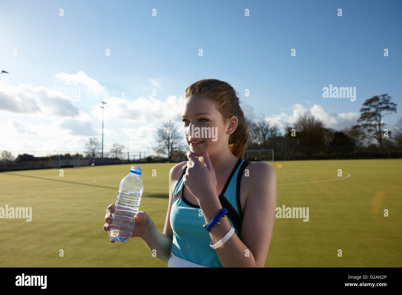 Girl drinking water in field Stock Photo - Alamy