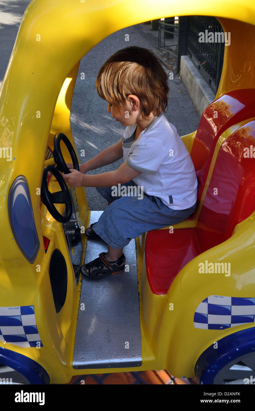 5-years old young boy in a Merry-go-round Car Stock Photo - Alamy