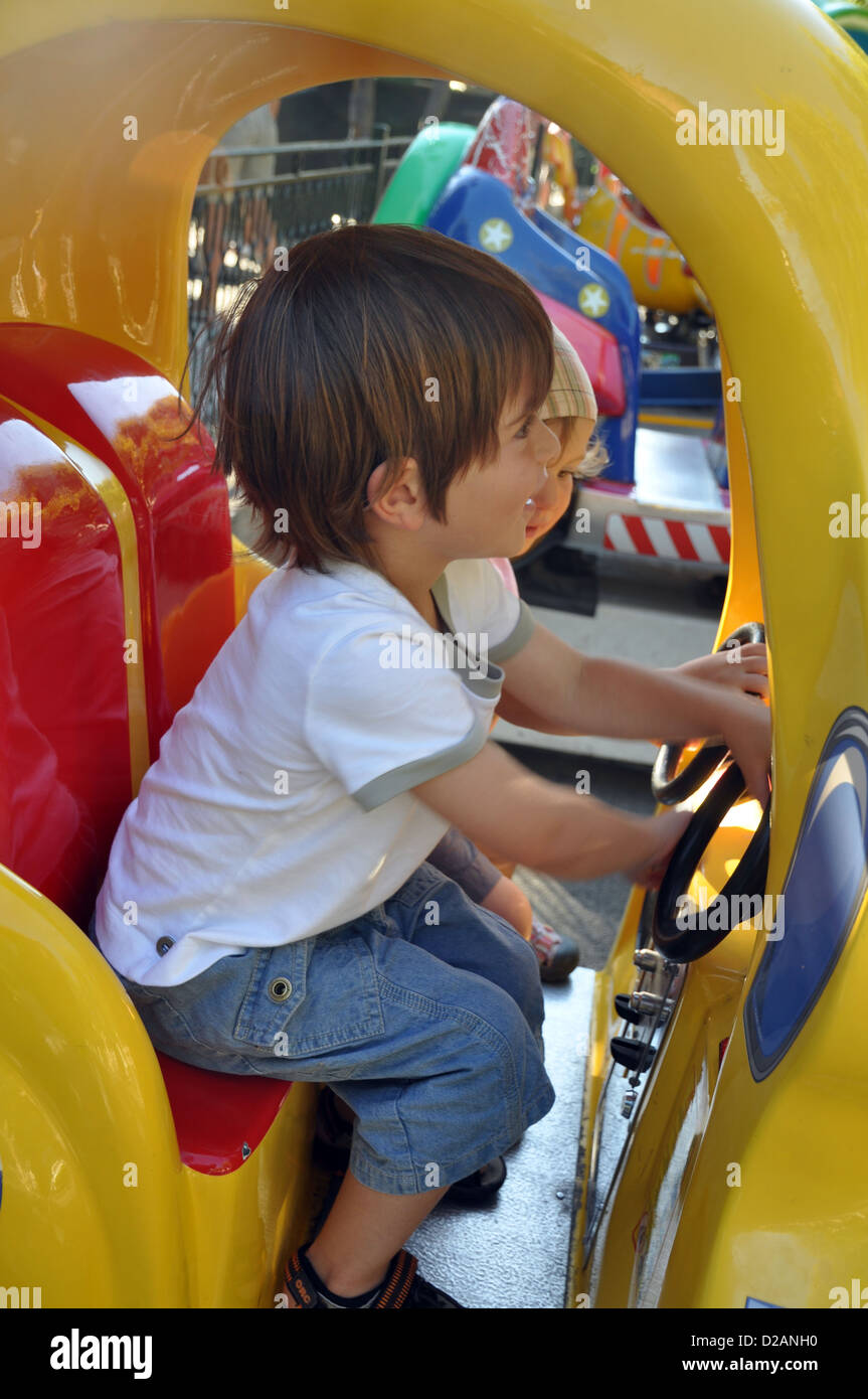 5-years old young boy in a Merry-go-round Car Stock Photo - Alamy