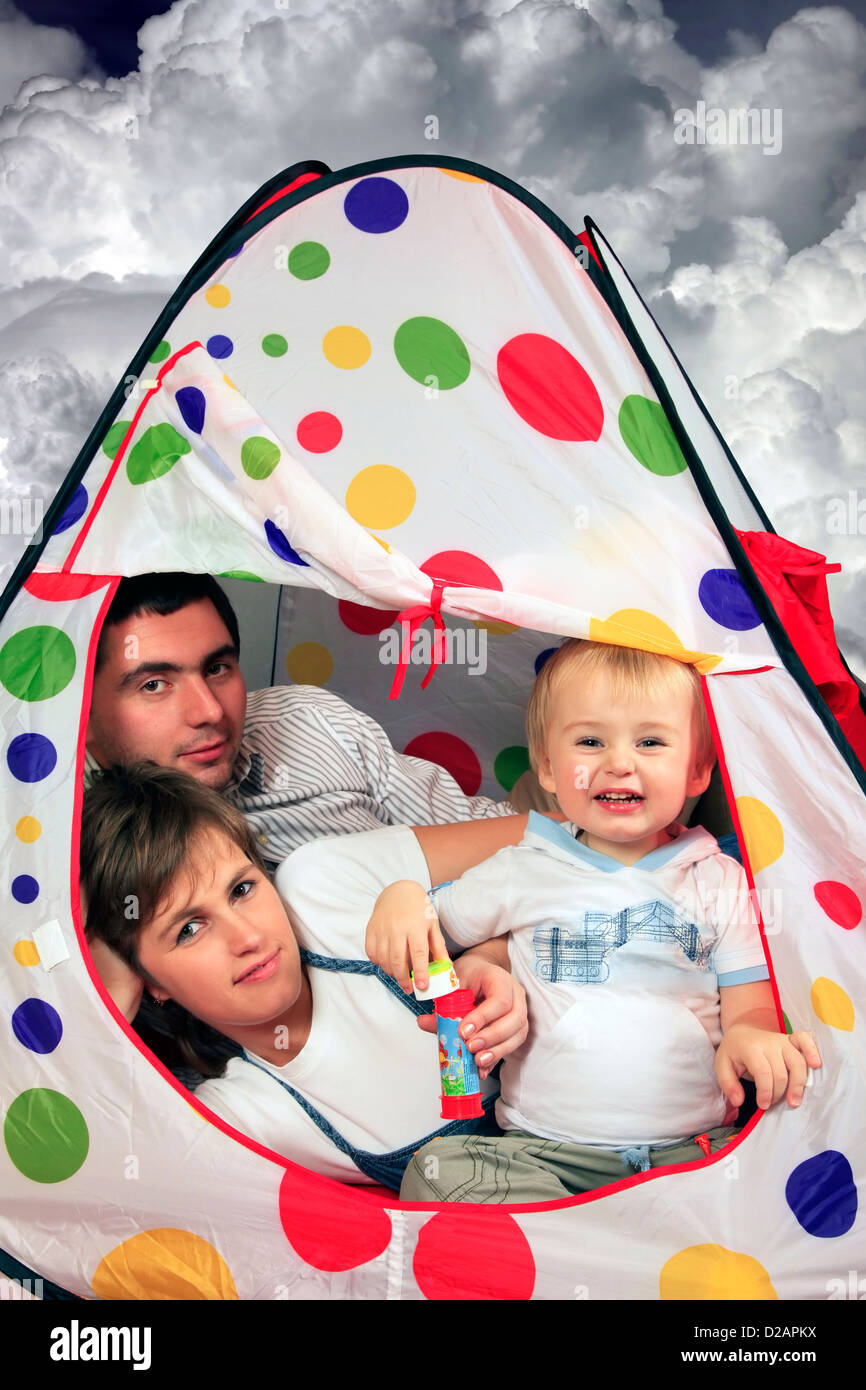 Happy young family with the son in a small house on a background of ...