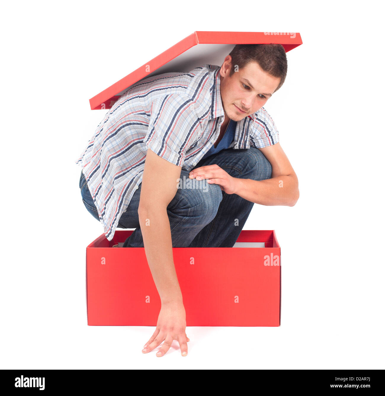 Young man in a box, seems stuck in his thoughts Stock Photo - Alamy