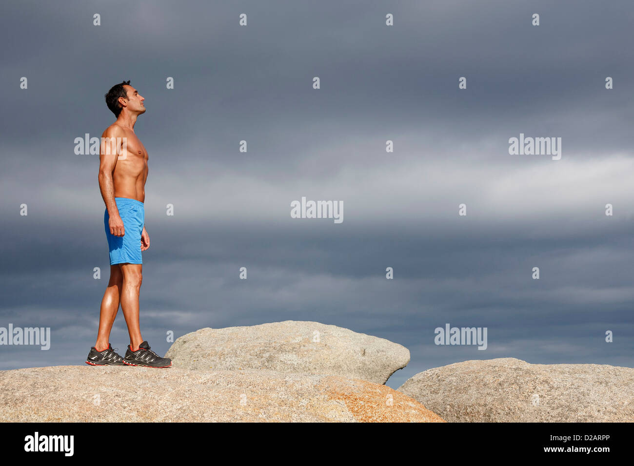 Man walking on boulder Stock Photo - Alamy