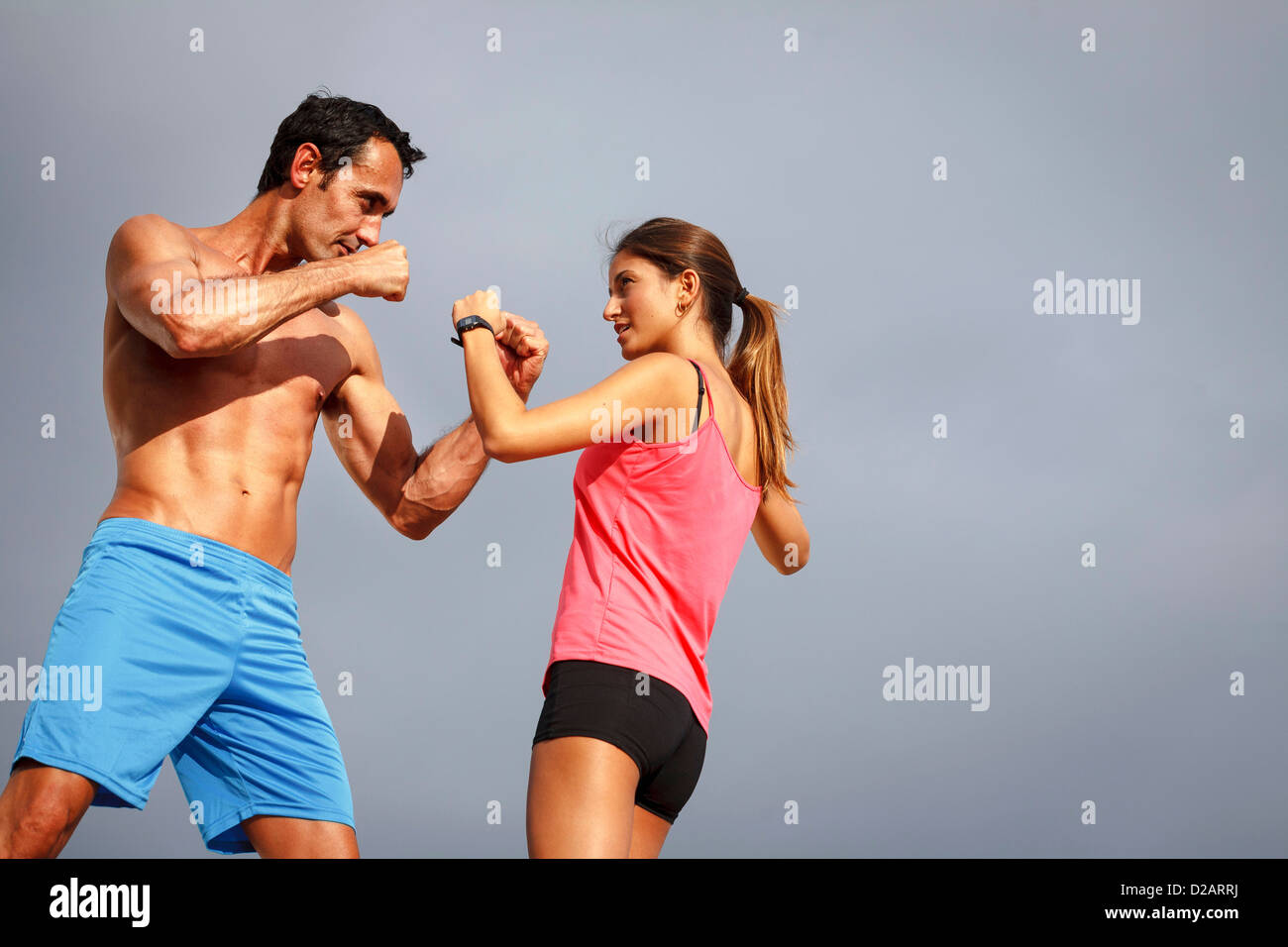 Couple boxing on boulder Stock Photo - Alamy
