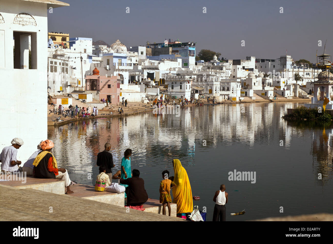 RELIGIOUS BATHING AT THE PUSHKAR GHATS WITH PILGRIMS ON TEMPLE STEPS ...