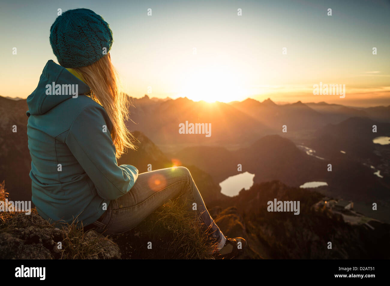 Hiker sitting on rocky hilltop Stock Photo - Alamy