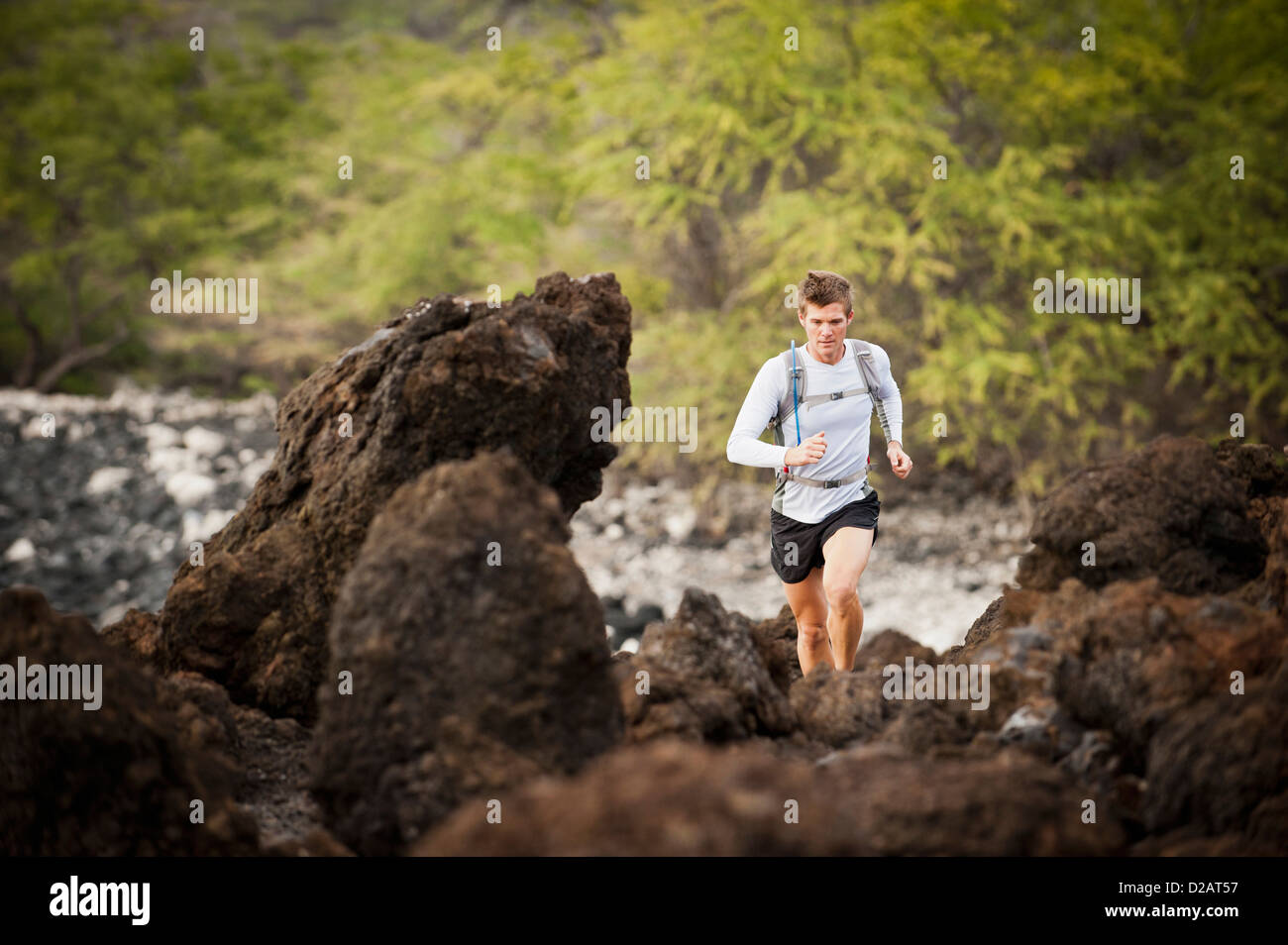 Man running on rocky rural trail Stock Photo - Alamy
