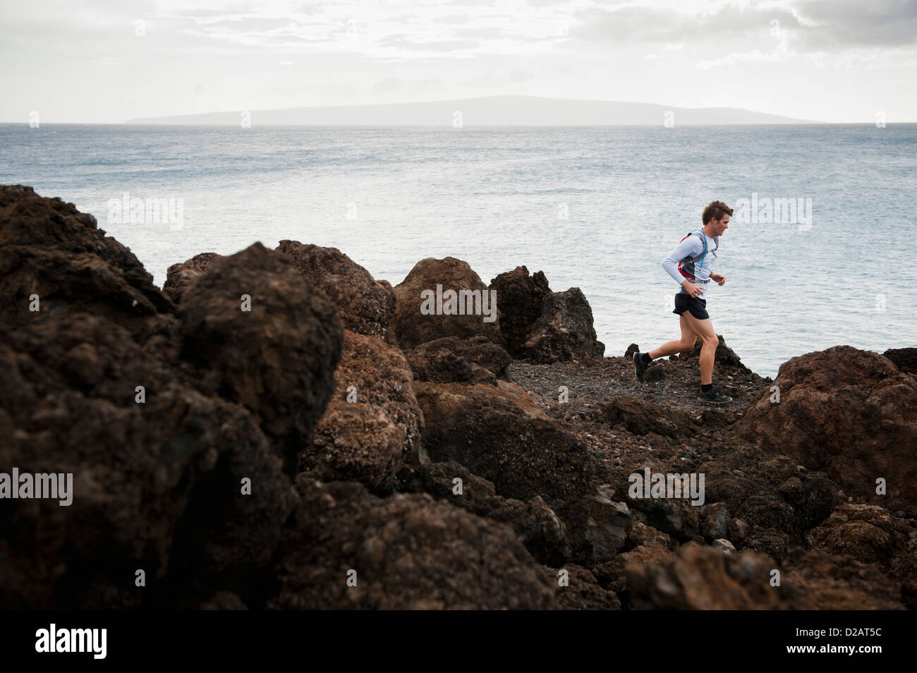 Man running on rocky rural trail Stock Photo - Alamy