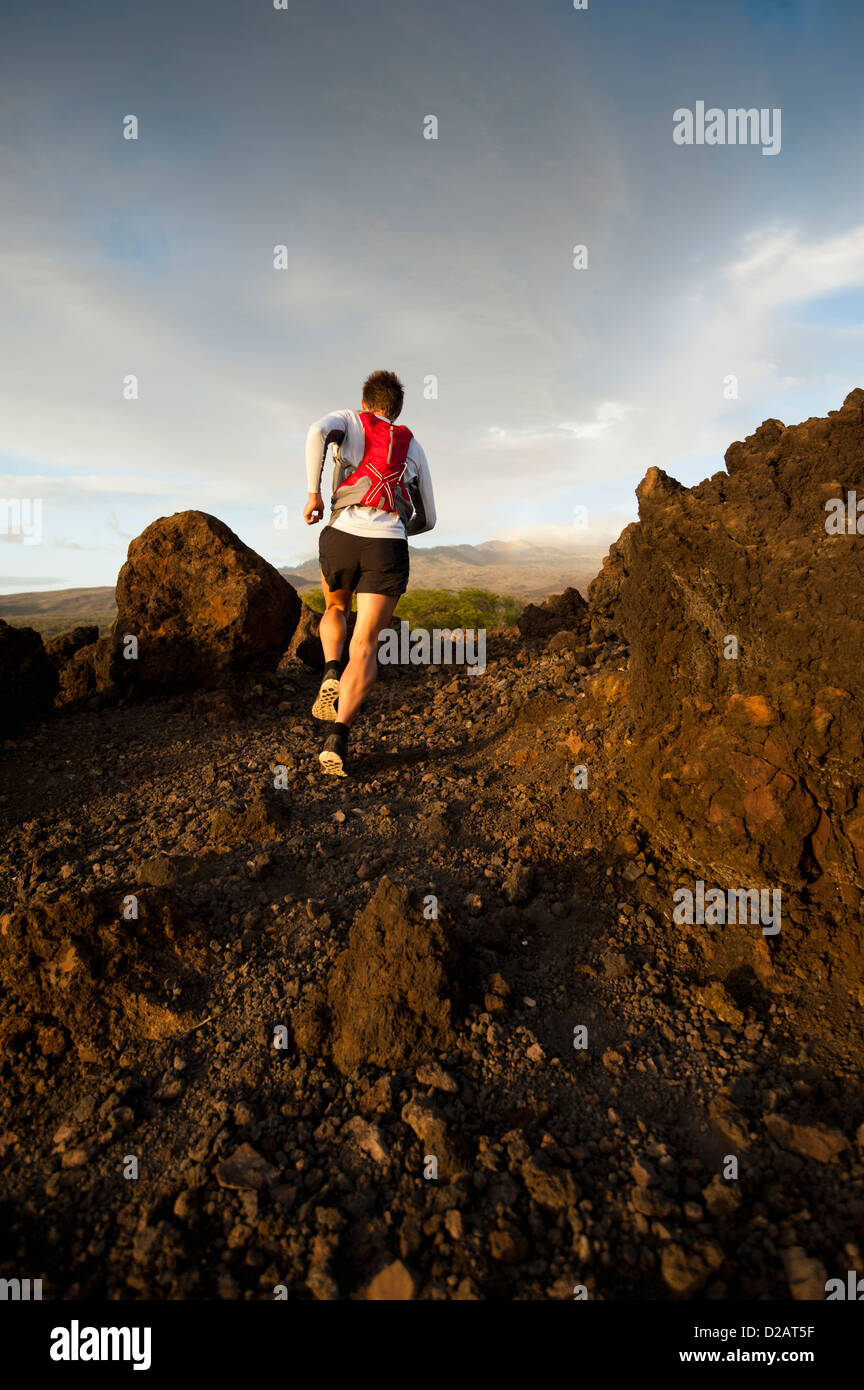 Man running on rocky rural trail Stock Photo - Alamy