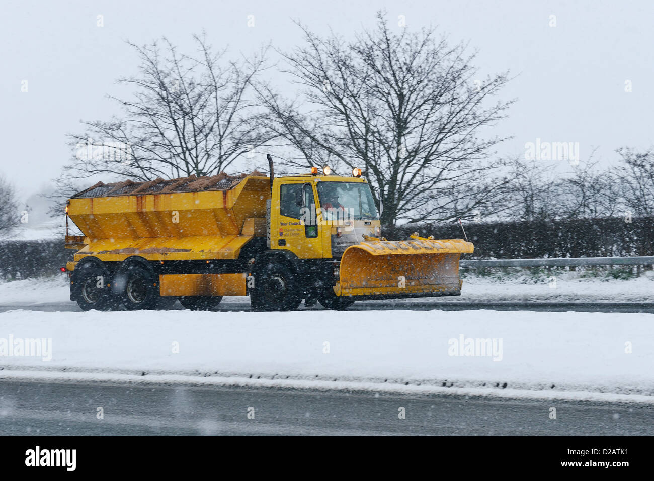 Snow plough on a dual carriageway UK Stock Photo - Alamy