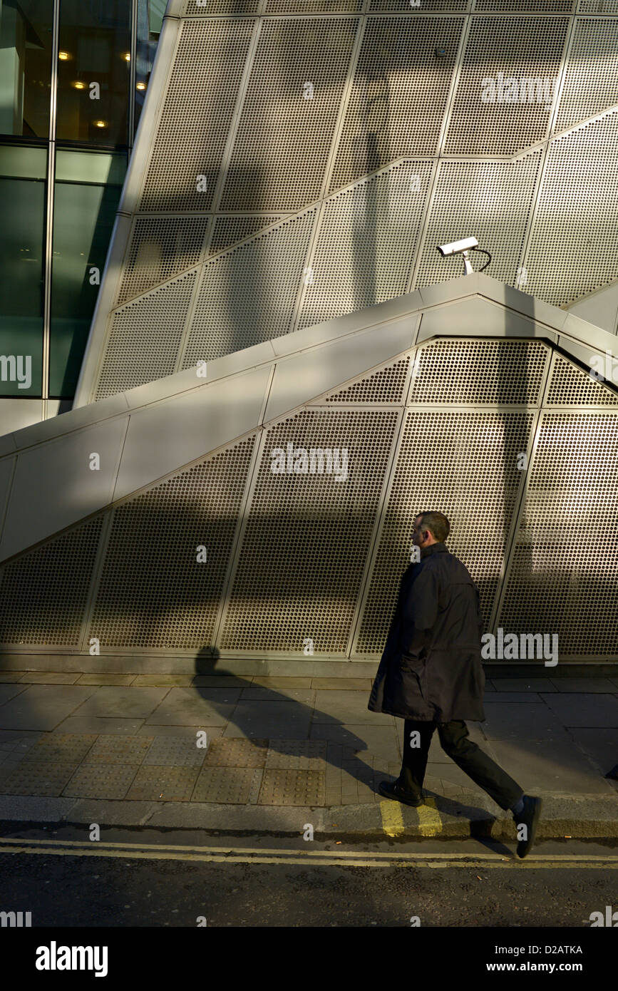 city of london man walks pavement cctv camera Stock Photo - Alamy