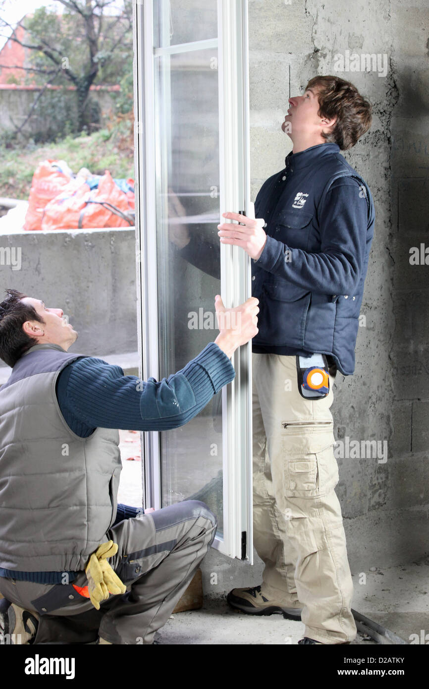 Two men installing new windows Stock Photo - Alamy