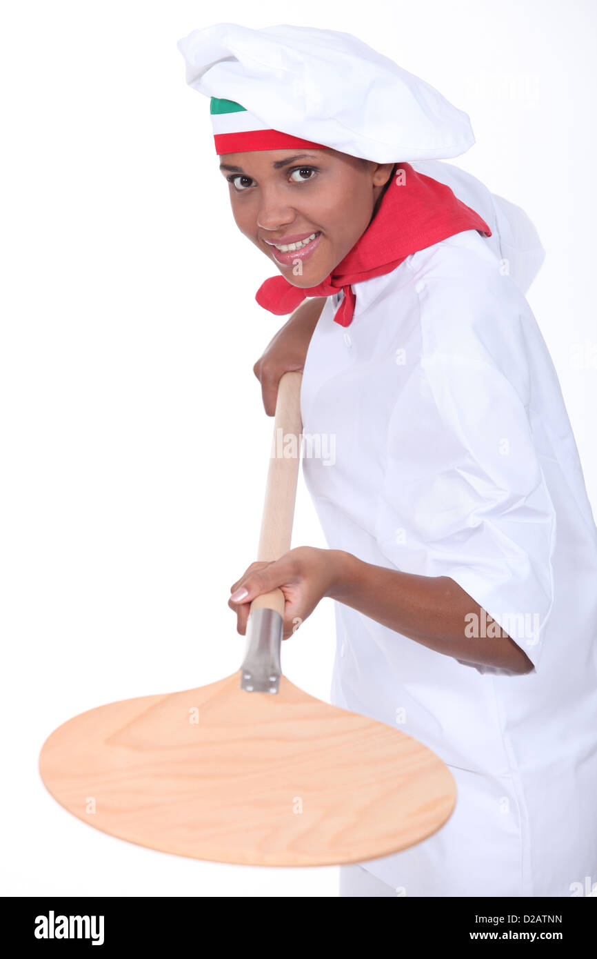 female pizza cook using a spade Stock Photo - Alamy