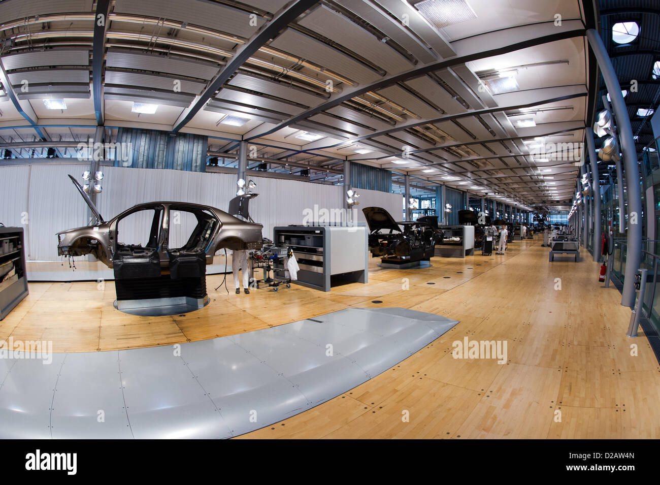 Employees of car manufacturer Volkswagen (VW) work on a VW Phaeton at ...
