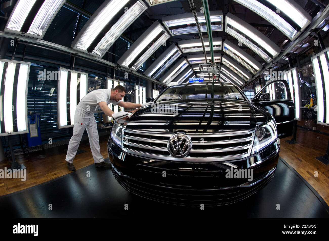 An employee of car manufacturer Volkswagen (VW) conducts the final ...