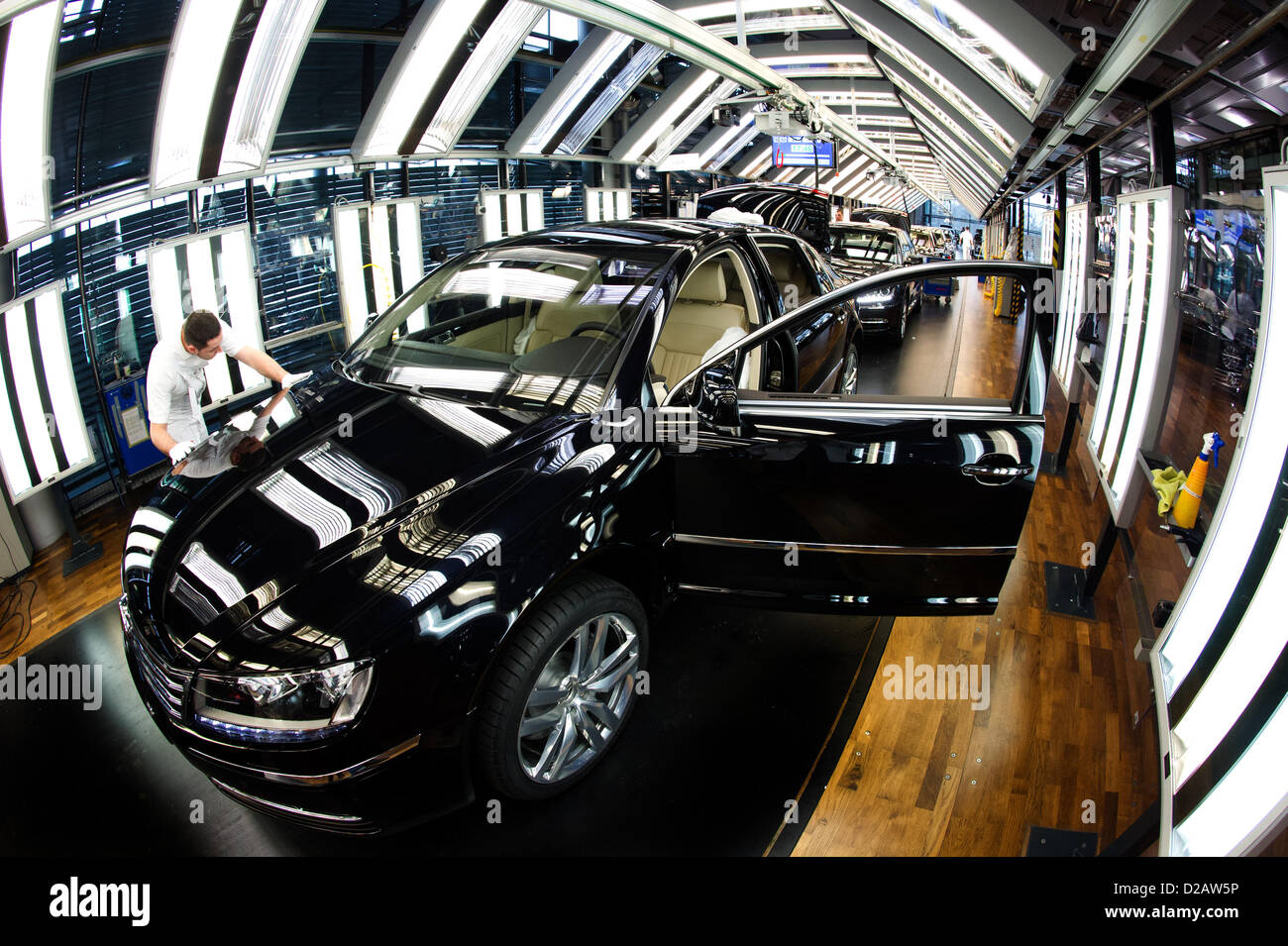 An employee of car manufacturer Volkswagen (VW) conducts the final ...